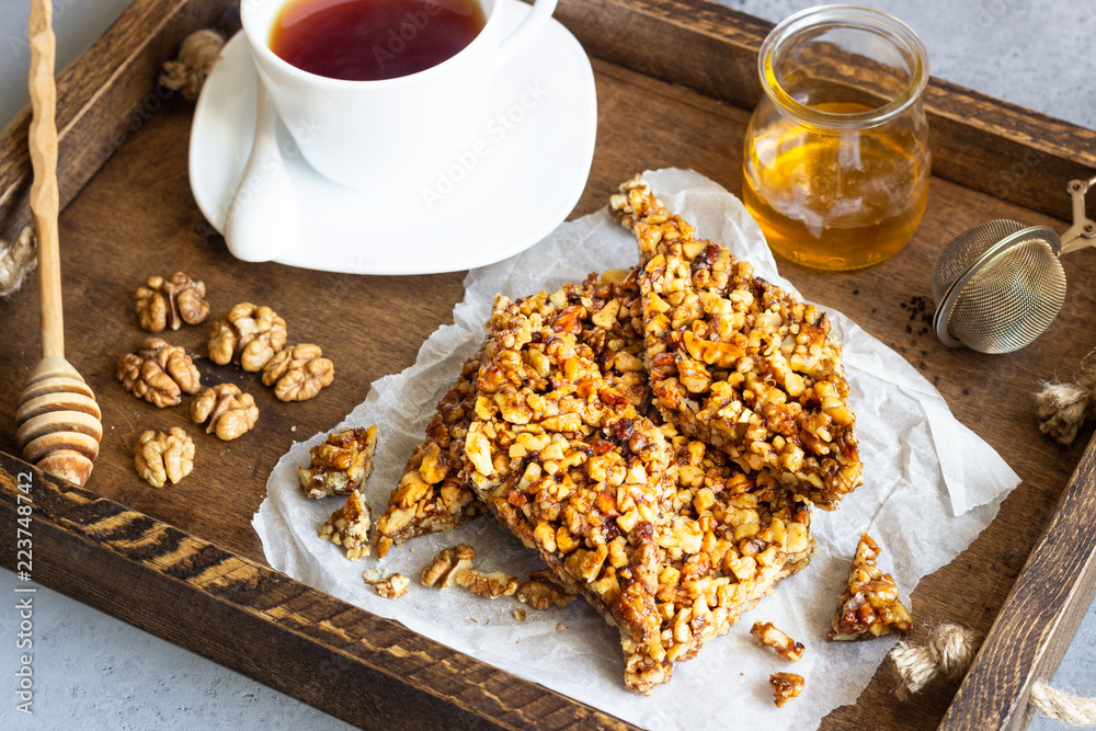 Dessert bars made of walnuts in a honey caramel. Gozinaki - traditional ...