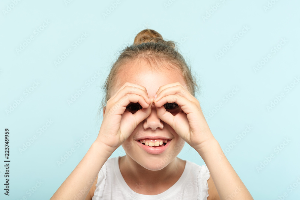 funny ludicrous joyful comic playful girl pretending to look through ...
