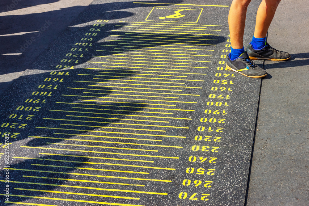 The scale for the standing long jump competition with legs of young ...