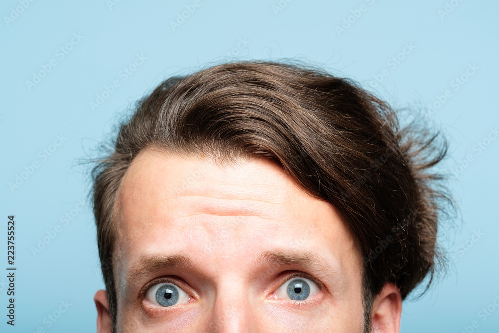 worried nervous man with alarmed look peeping out from the bottom of ...