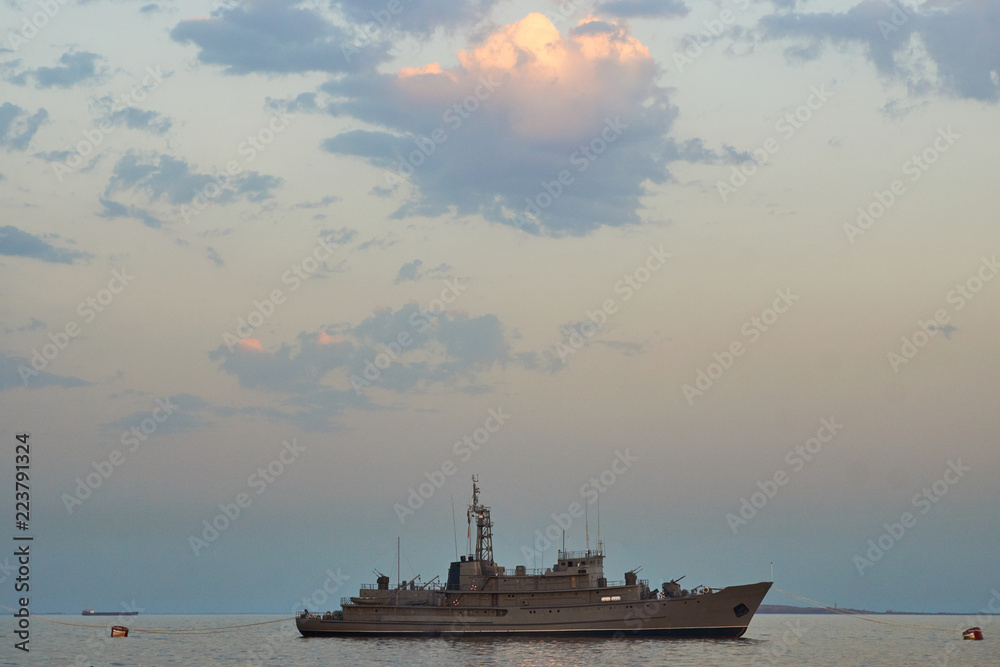 Military Battleships in a sea bay at sunset time. Modern warship ...