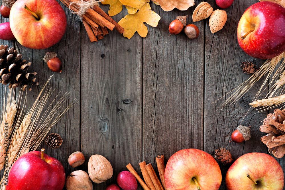 Autumn frame of apples and fall ingredients on a rustic wood background ...