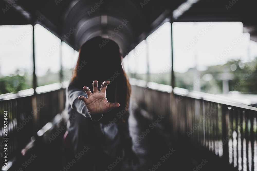 Scary ghost woman image standing between the middle of the walkway with ...