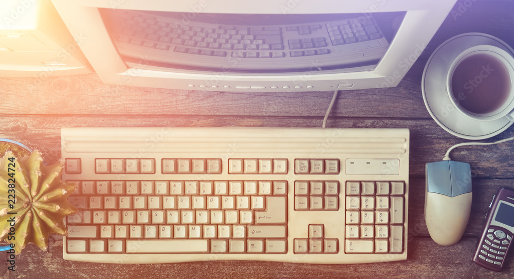 Foto de Retro stationary computer on a rustic wooden desk, vintage ...