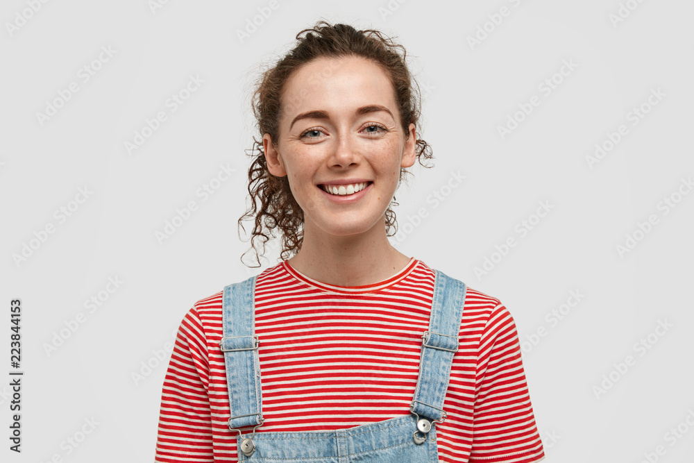 Horizontal Shot Of Happy Freckled Woman Adult With Curly Hair Pleasant