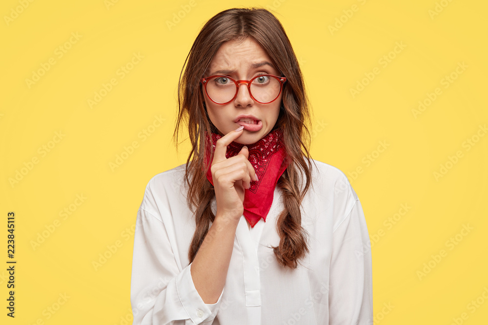 Embarrassed hipster or female teenager has displeased facial expression ...