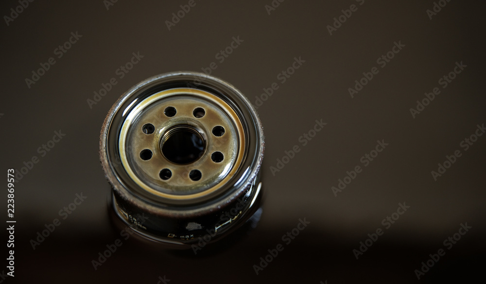 Used oil filter stands in old oil. The process of replacing the engine ...