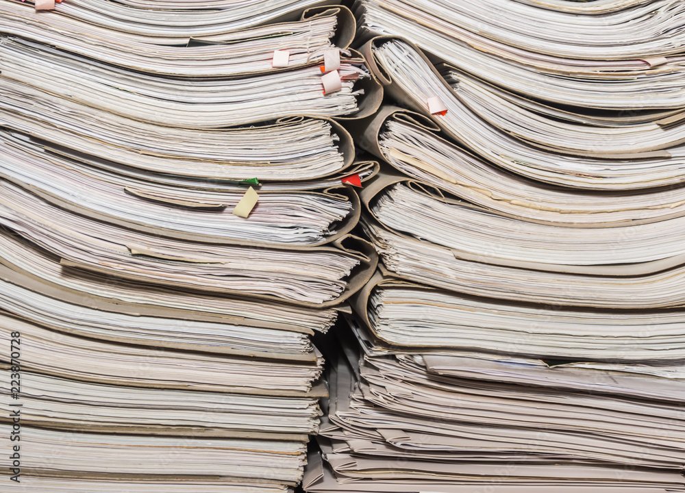 Old paper documents stacked in archive. Documents on the shelves of ...