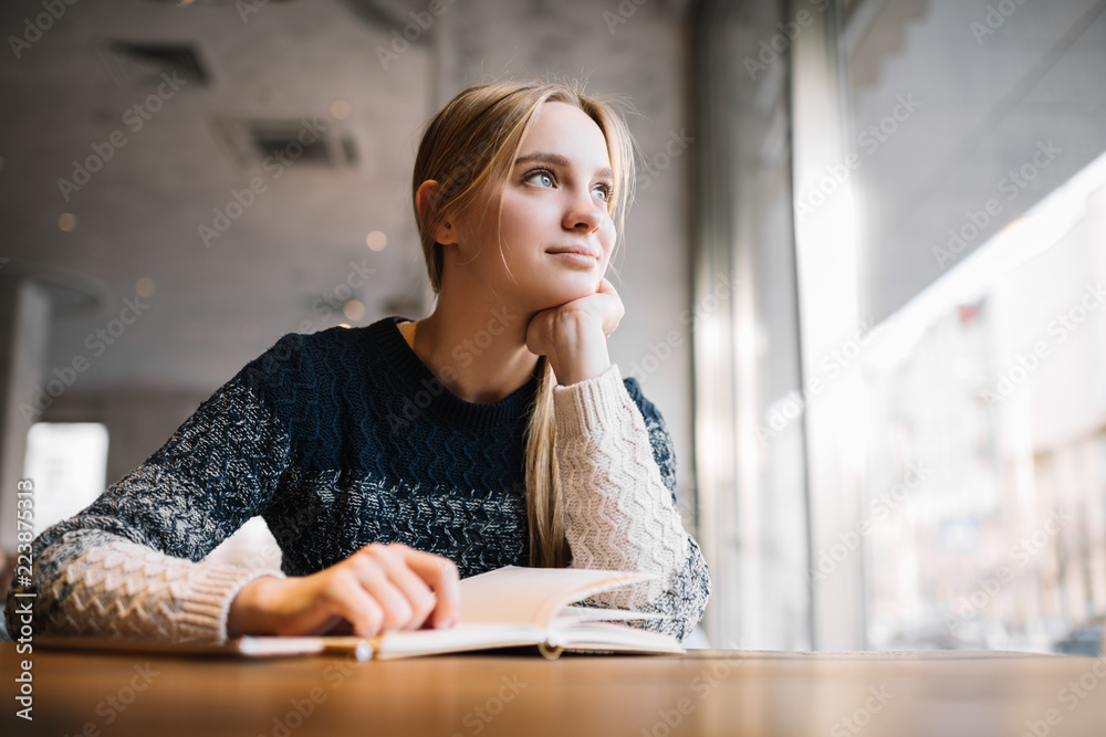 Young attractive university student studying at modern library. Cute ...