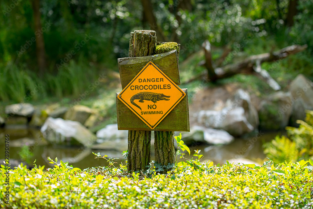Danger crocodiles, no swimming - warning sign locaDanger crocodiles, no ...