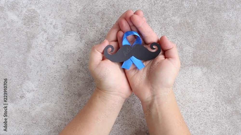 Vidéo Stock Mustache pattern with blue ribbon symbol in child's hands ...