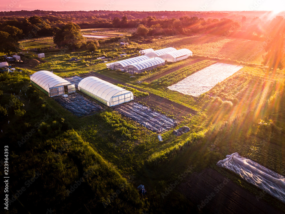 Drone aerial photography of an organic inner city farm taken at sun set ...