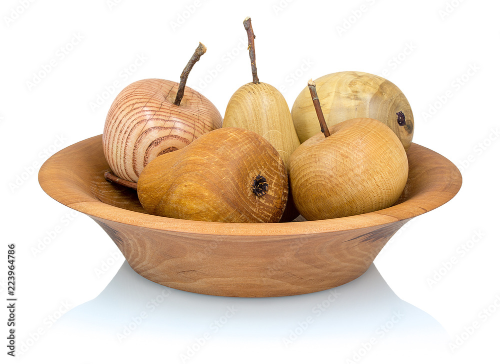 Wooden apples and pears in a fruit bowl made from a different types of ...