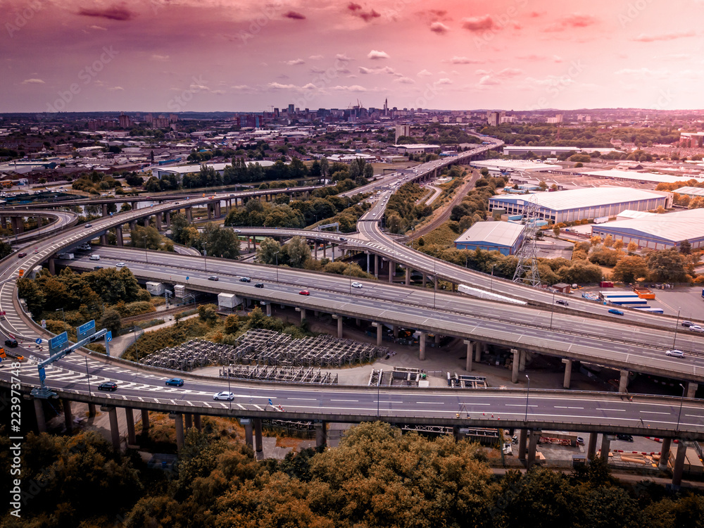 Aerial view of a complex motorway road junction with traffic moving ...