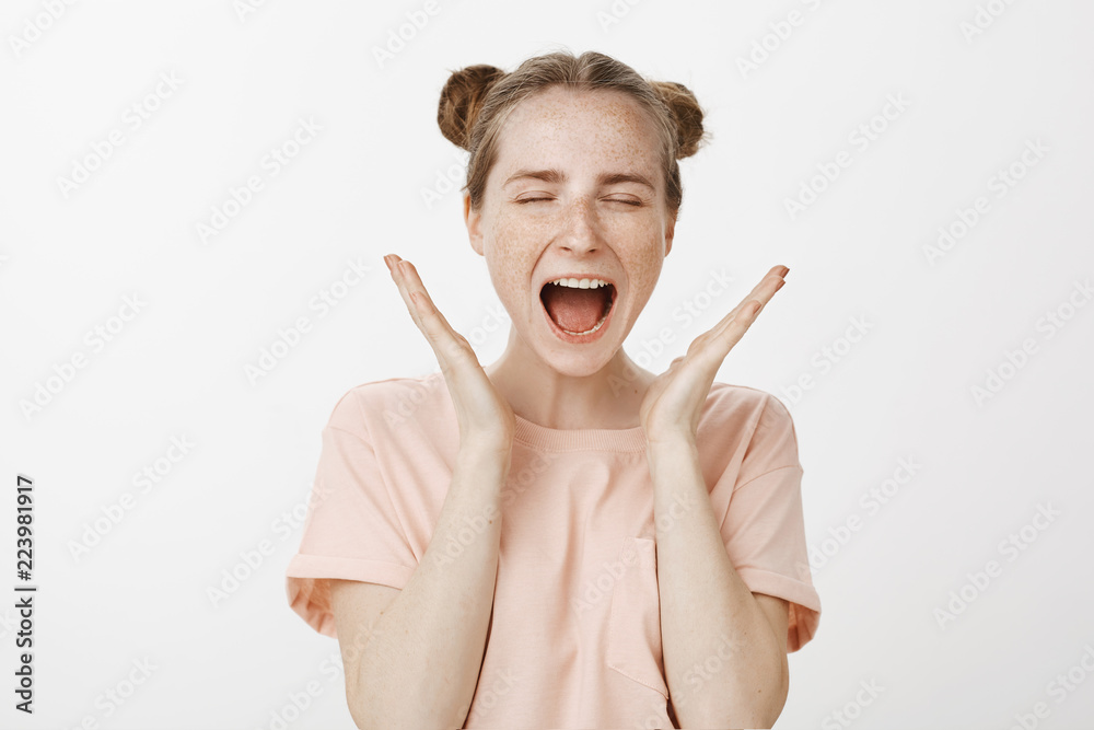 Amused and carefree hapy girl feeling great receiving amazing surprise ...