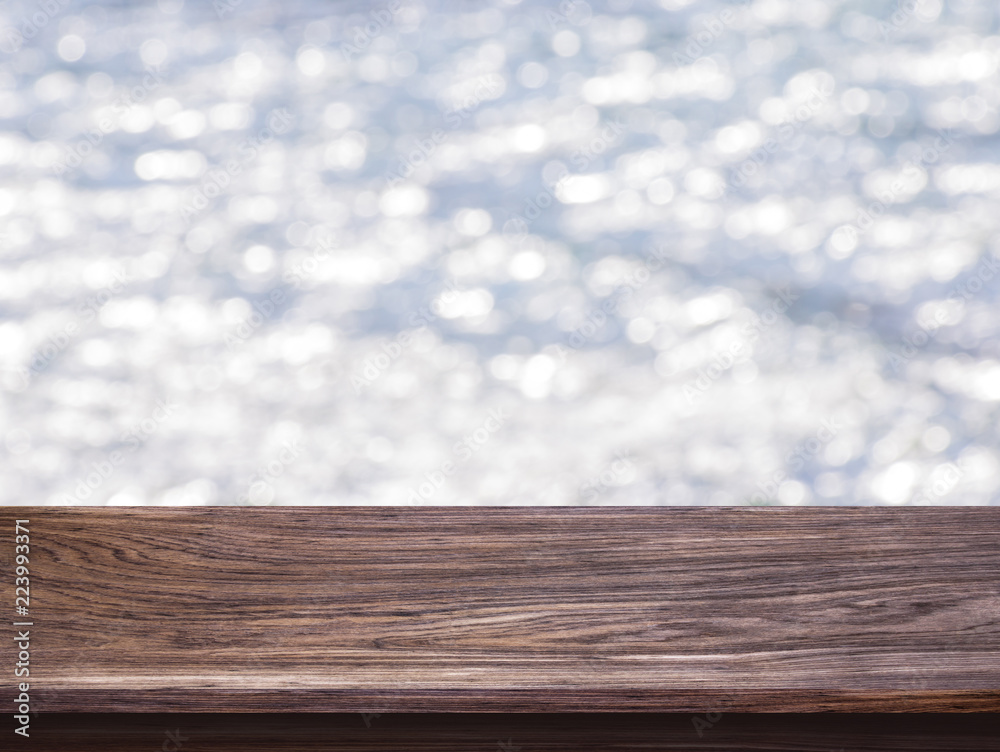 Wood table top on bokeh light gray background. For montage product ...
