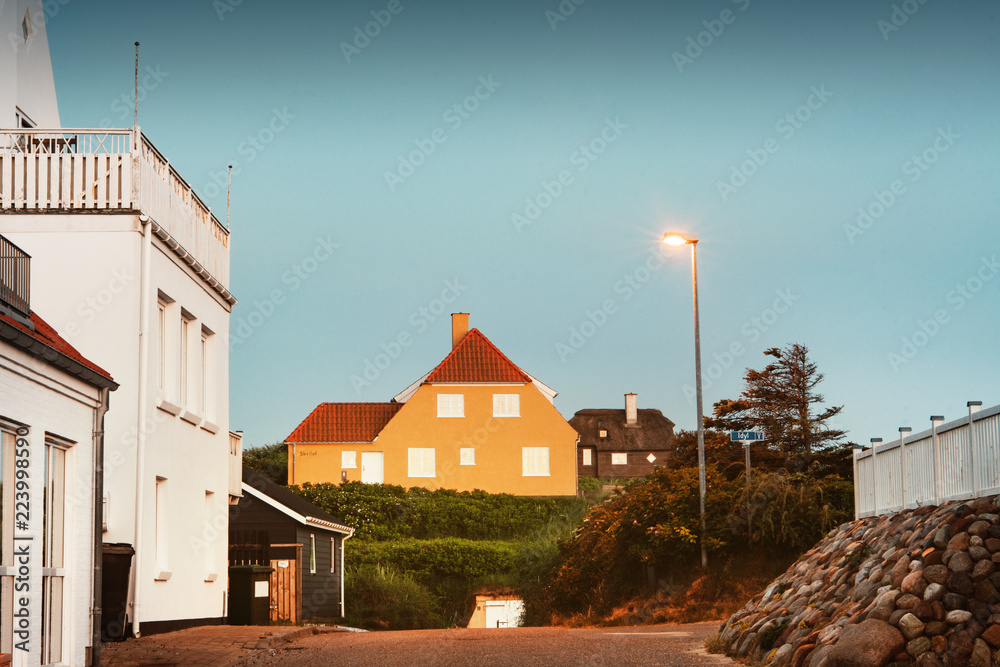 Beautiful sunset light street view with yellow houses which are typical ...