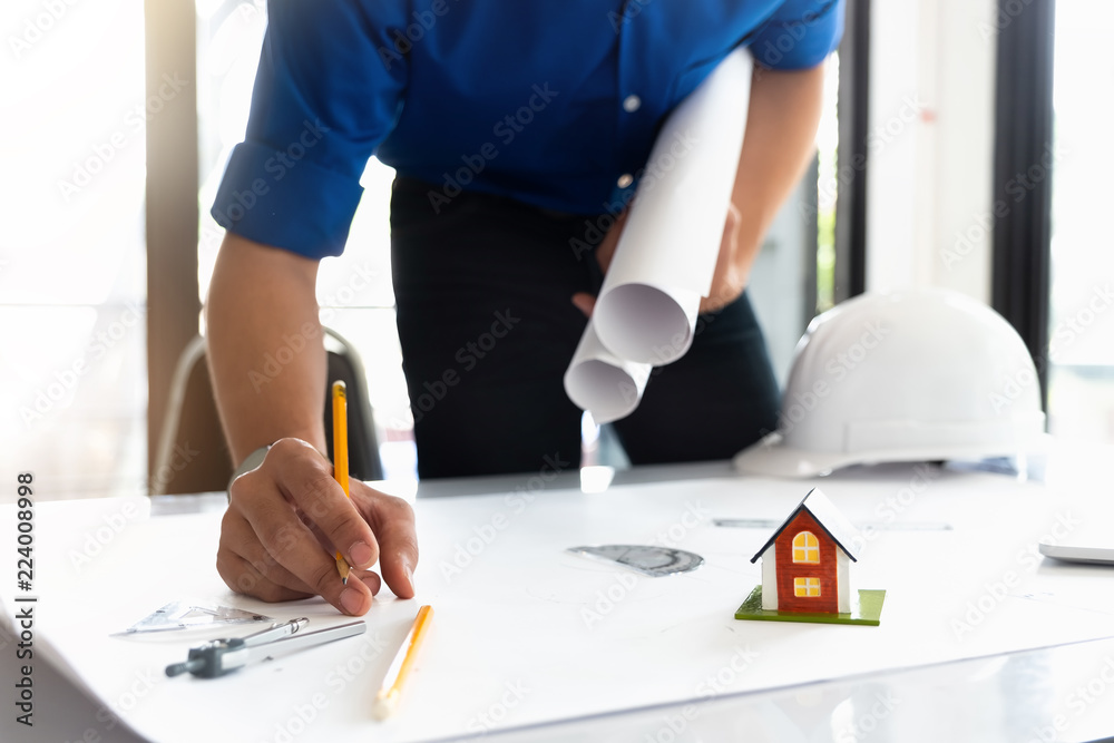 Image of engineer drawing a blue print design building or house, An ...