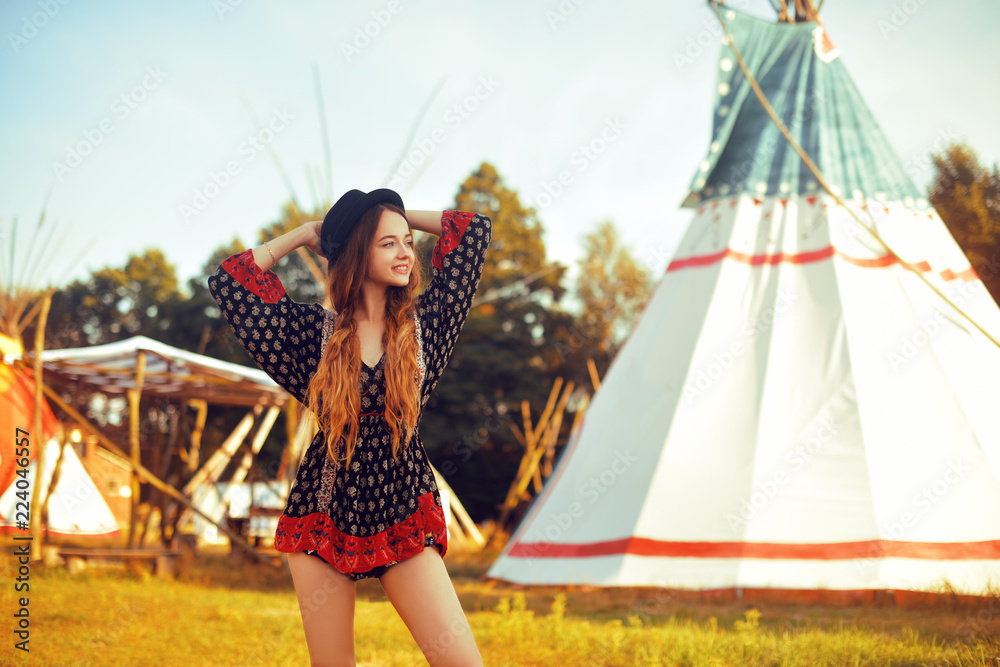 Young beautiful girl smiling on background teepee, tipi- native indian ...
