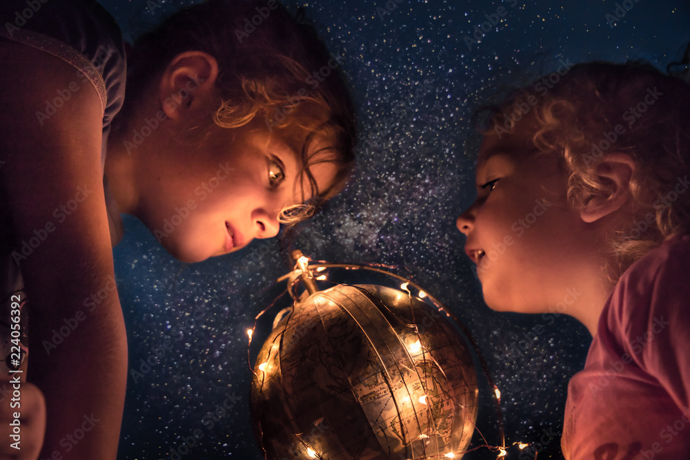 Children exploring night sky with space stars and earth planet concept ...