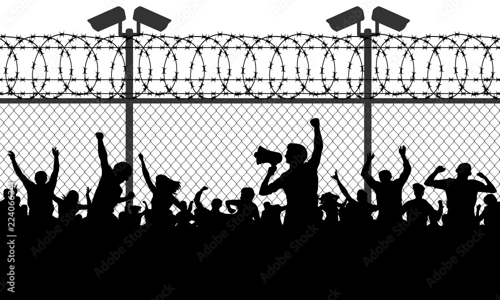Crowd of people behind bars demanding to open the border. Migrants and ...