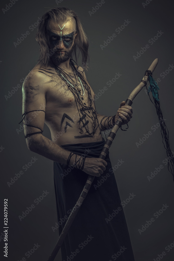 Dark tribal shaman or warlock summoning spirits using a deer skull and ...