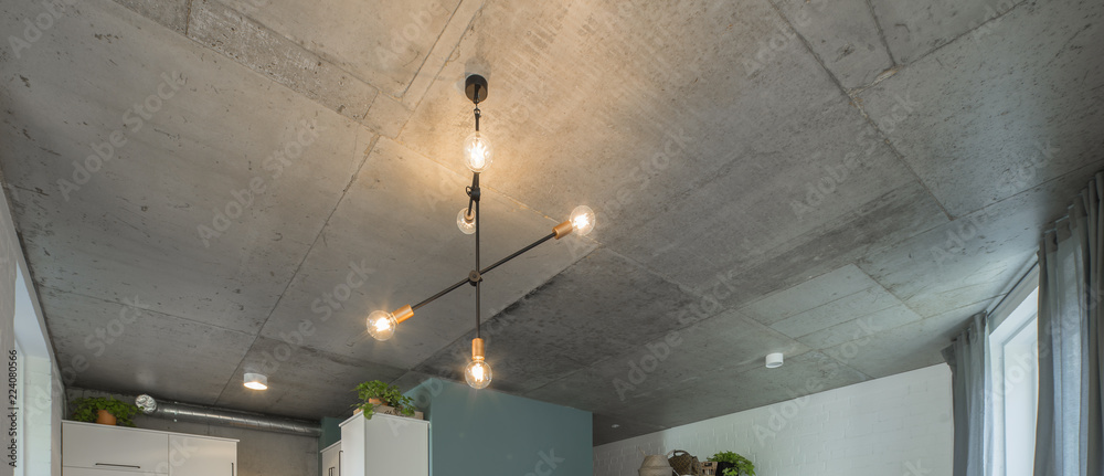 Concrete ceiling and lighting in a modern apartment. Concrete style in ...