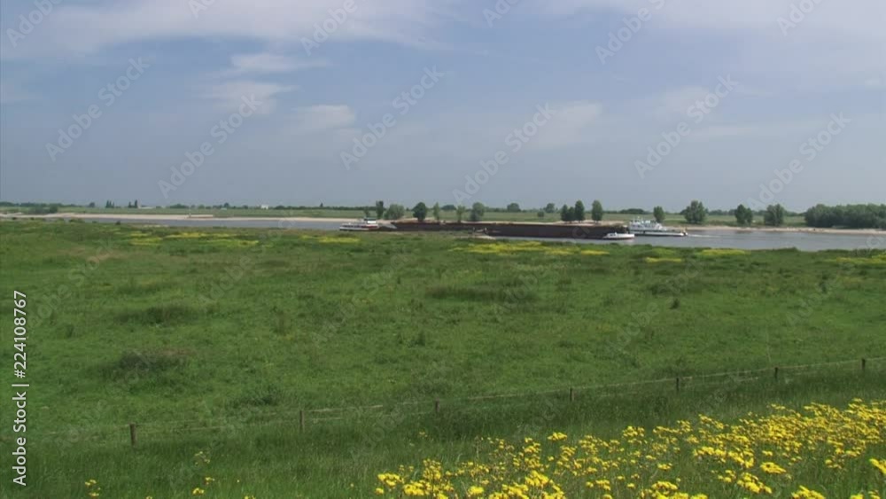 Barges, inland ships crossing on Waal River - wide shot. The Dutch ...