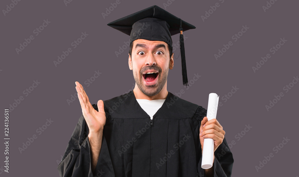 Man on his graduation day University with surprise and shocked facial ...