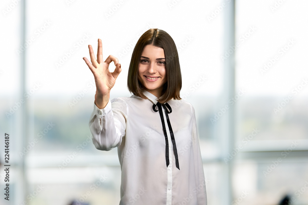 Beautiful woman showing ok sign. Happy cheerful girl in formal wear ...