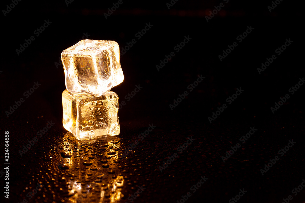 Golden ice cubes on black background. Stock Photo | Adobe Stock