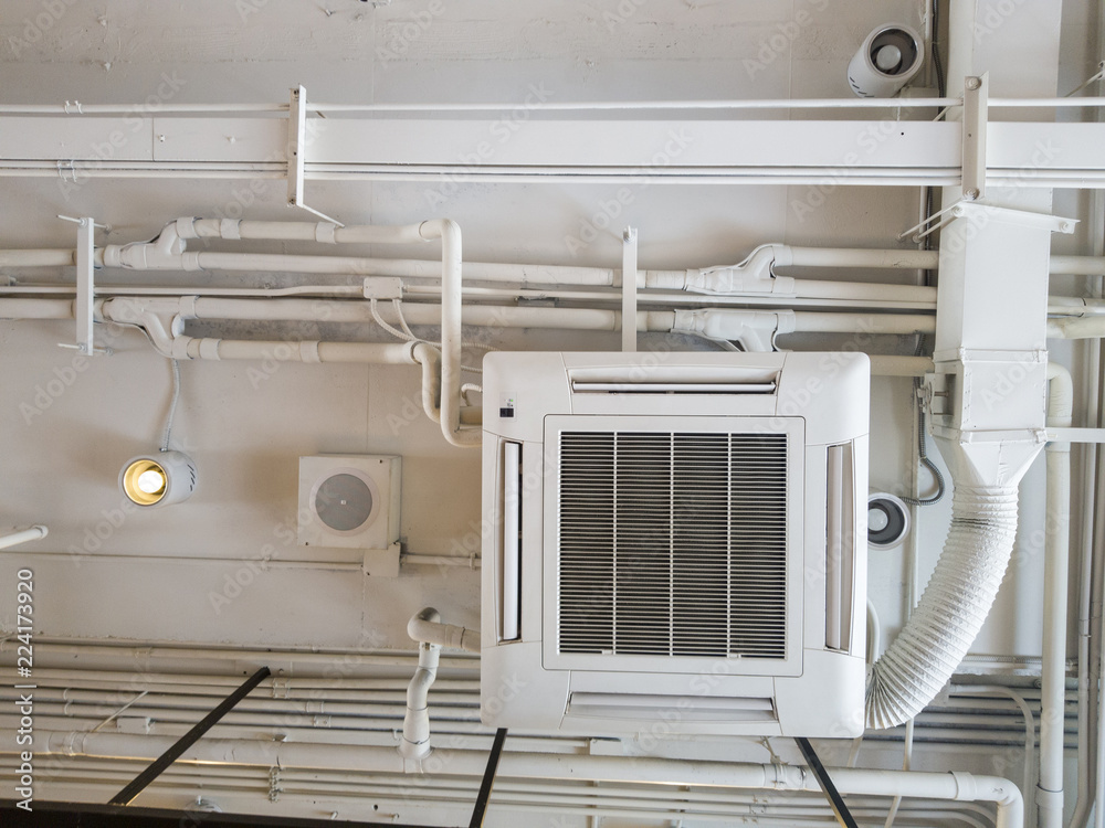 White Industrial air conditioner cooling pipe with plumbing at ceiling ...
