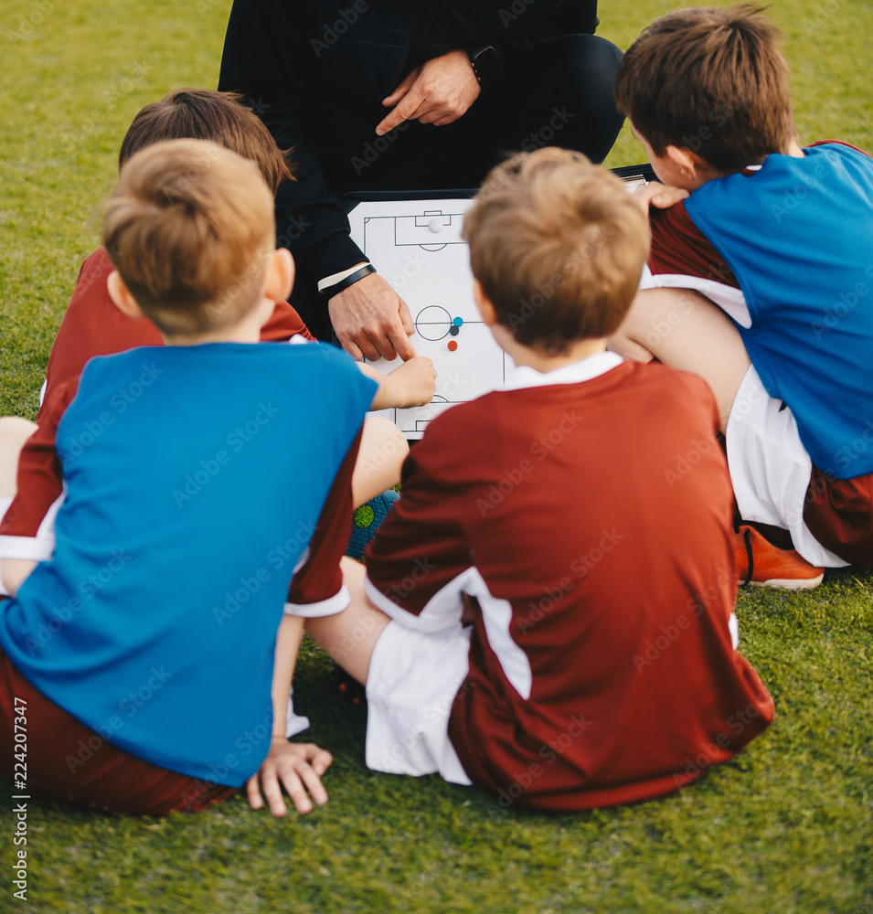 Kids Football Team with Coach at the Soccer Field. Youth Coach ...