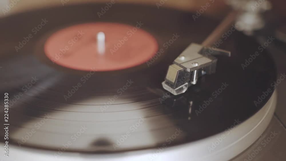 An old dusty record player from the 1970's is playing a black vinyl ...