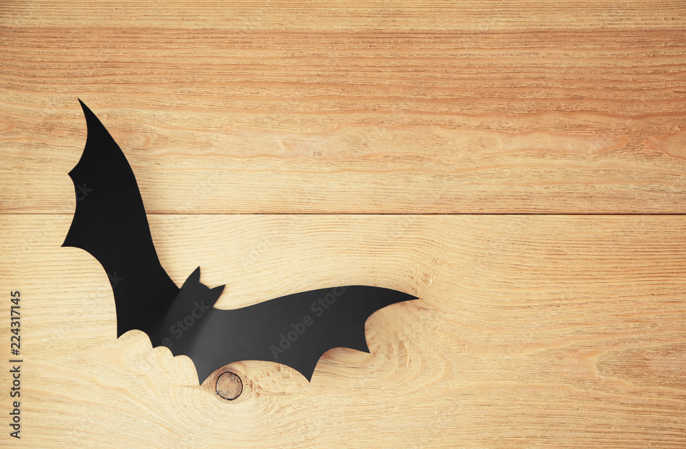 Paper bat as decor for Halloween party on wooden background Stock Photo ...