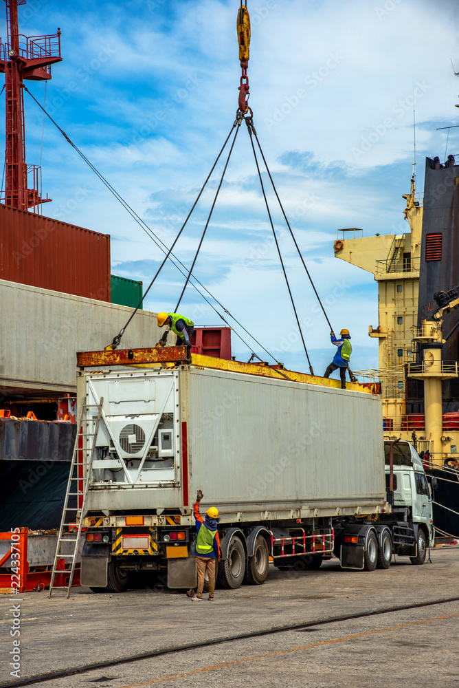 container unit being lift loading by the ship crane from the trailer to ...