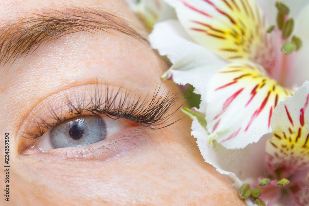 Beauty and fashion concept - Eyelash Extension Procedures. girl with ...