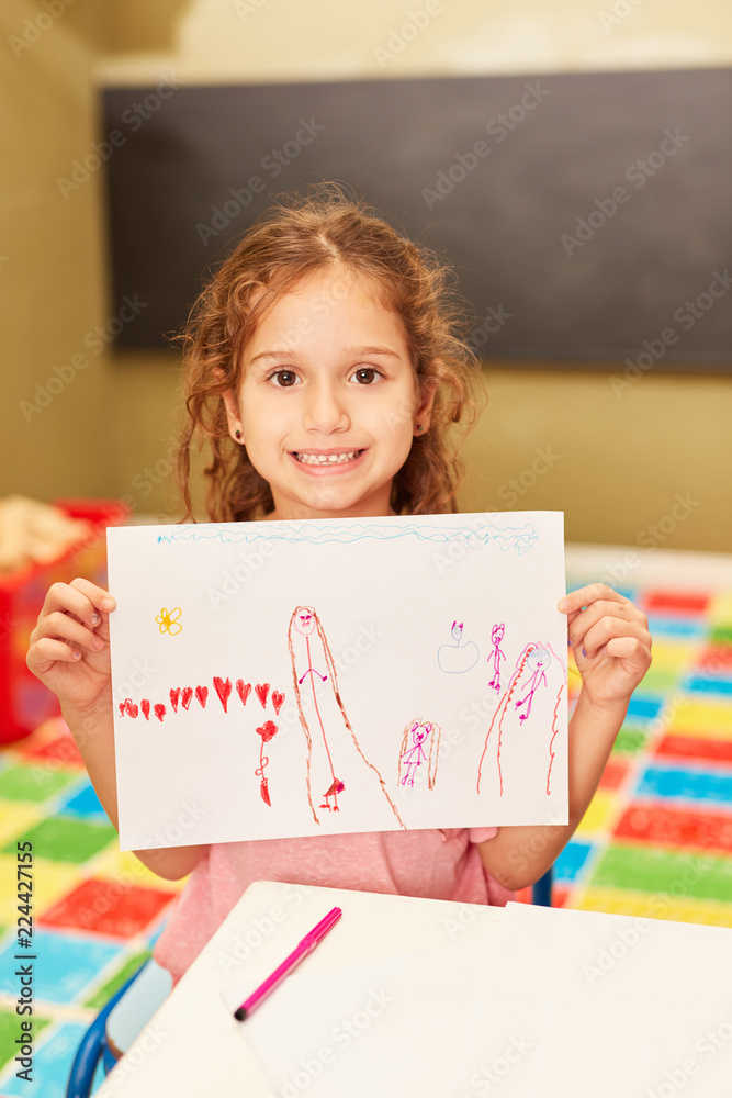 Mädchen zeigt stolz ein Bild im Malkurs Stock Photo | Adobe Stock
