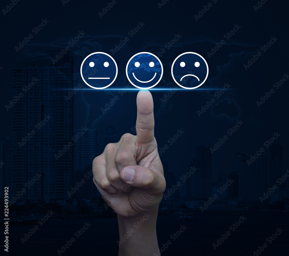 Hand pressing excellent smiley face rating icon over world map and ...