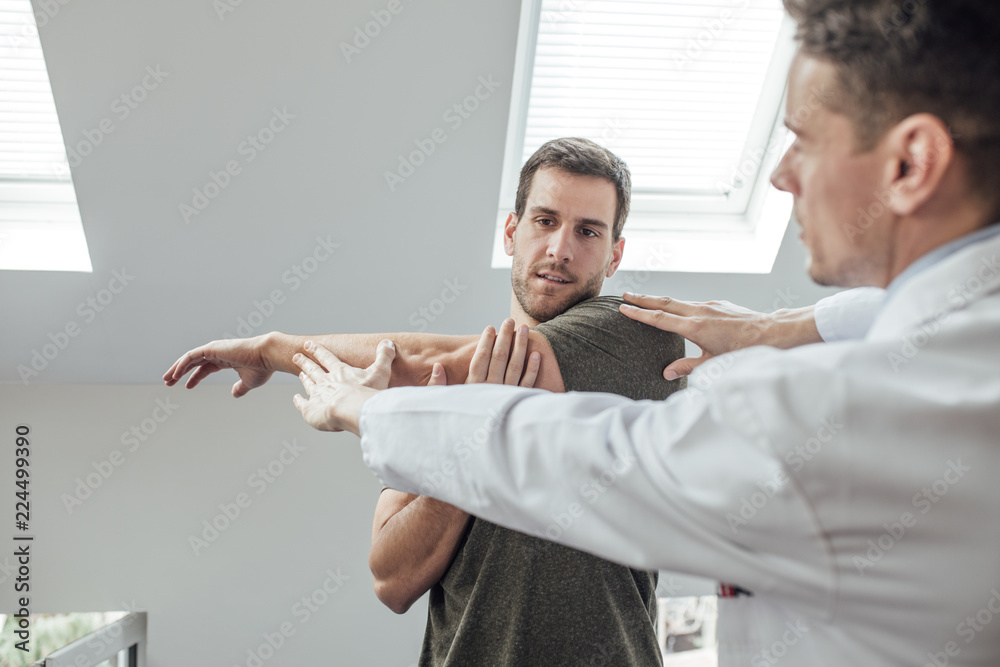 Patient Stretching His Arm Stock Photo | Adobe Stock
