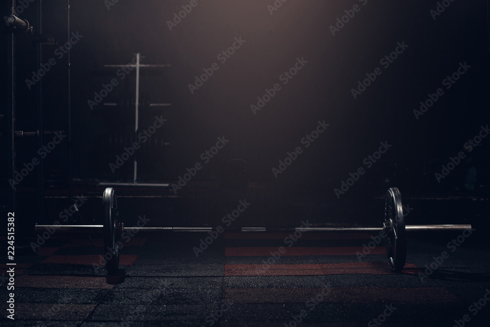 Bar for weight lifting on dark background in gym barbell. Stock Photo ...