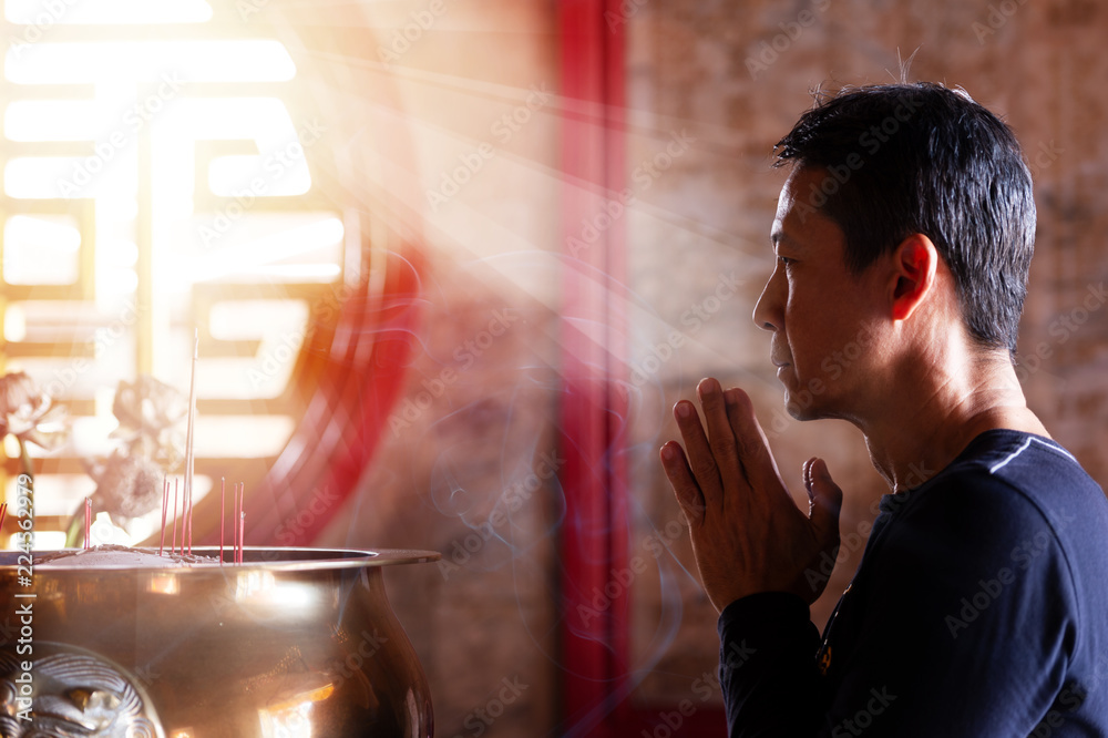 Faith and religious. .Man pressing hands together blessing in front of ...