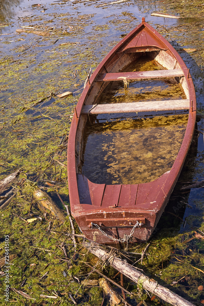 Old Boat Wreck. Small wooden wrecking boat full of water near the shore ...