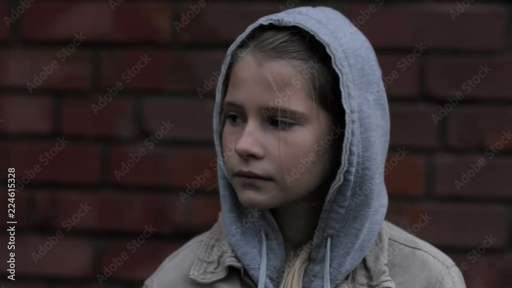 Refugee homeless child. Dark portrait of preteen girl standing in front ...