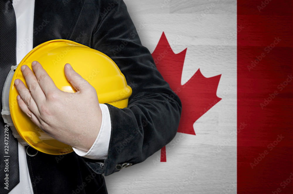Engineer with yellow plastic helmet on a Canadian flag background Stock ...