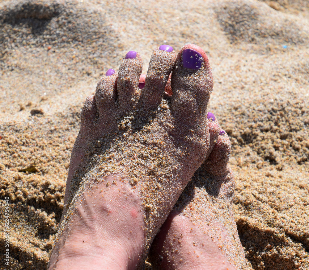 sandy toes in the sunshine, Close-up of woman's pedicured feet and toes ...
