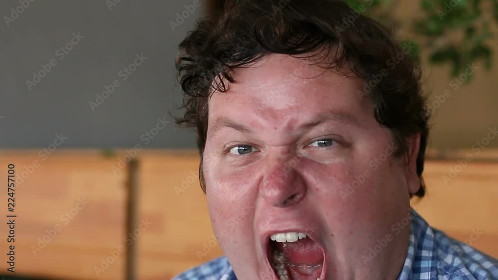 Excited fat man screams in rage, gaze with bugged eyes, shocked to hear ...