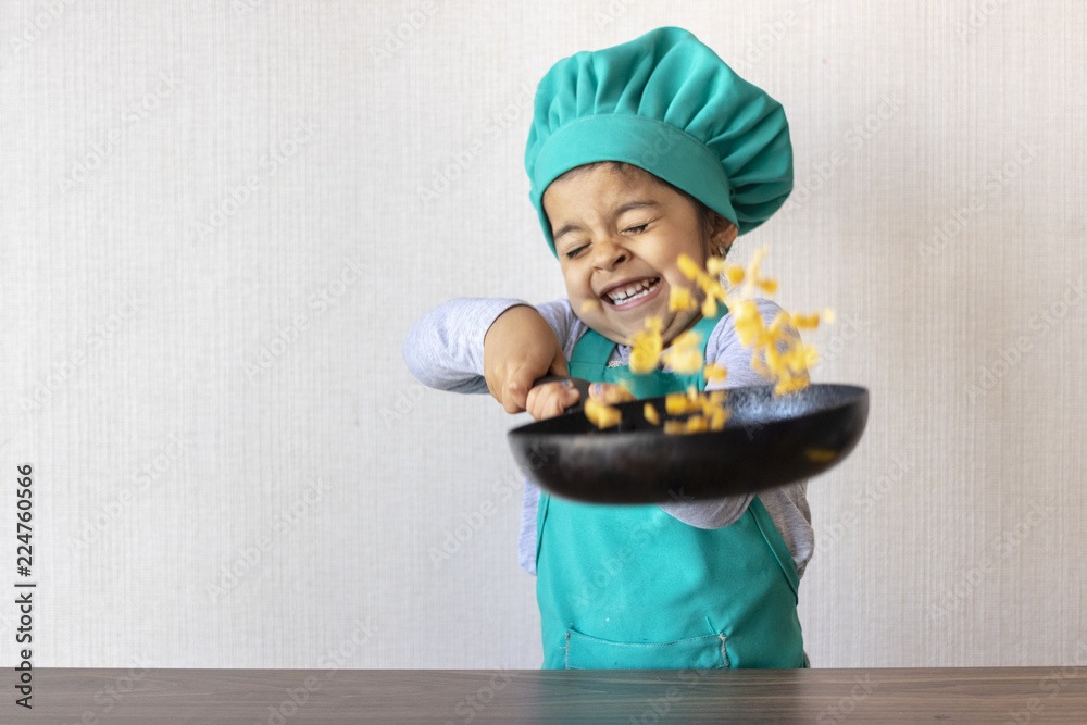 Cute little girl cooking with her frying pan Stock Photo | Adobe Stock