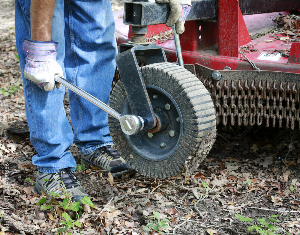 Mechanic repairs dirty and rusty brush cutter, tractor attachment Stock ...