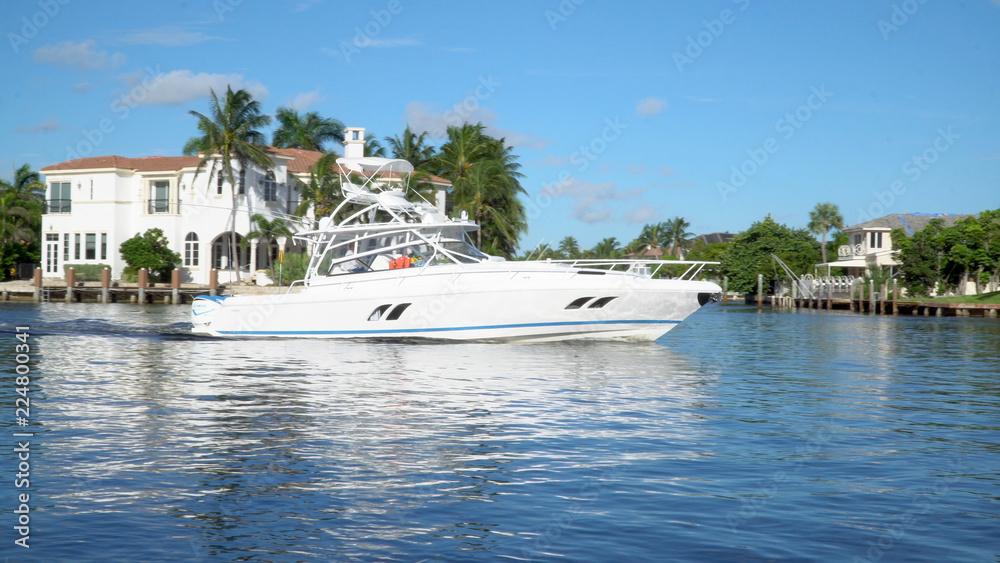 Large motor boat sailing through inner coastal waterway river during ...